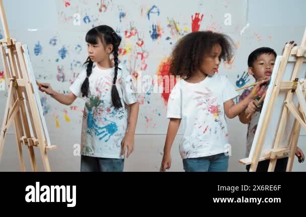 Diverse student painted or draw canvas at stained wall in art lesson ...