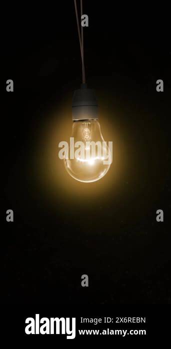 Vertical Flickering Yellow Light Bulb in the Dark 4K Loop features a ...