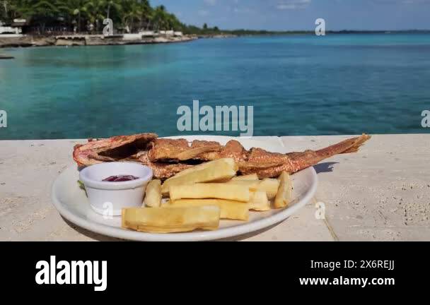 Fried fish as lunch in the beach. Fried fish and yuca ready to eat ...