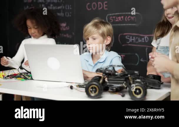 Closeup of boy using laptop programing engineering code and writing ...
