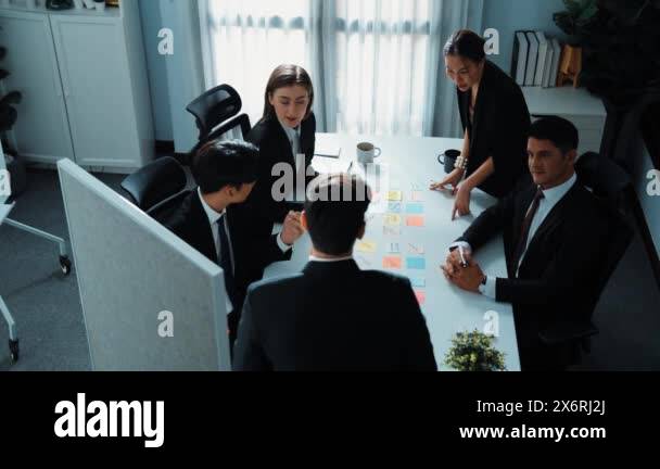 Top view of smart businessman putting sticky note on whiteboard while ...