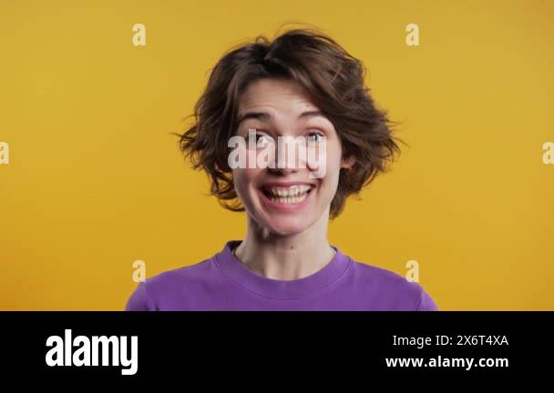 Gorgeous woman in violet outfit showing yes signal, nods head, approve ...