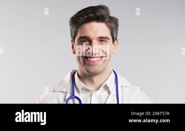 Smiling mid aged adult doctor man showing yes signal, nods head ...