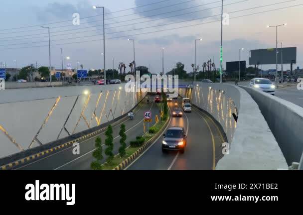 Time laps View of light vehicle traffic passing through under pass in ...