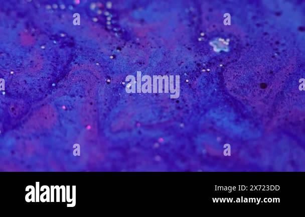 Bubble paint. Wet ink. Glitter water. Defocused blue purple color ...