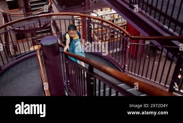 Girl, child and walking in library with books for research, education ...
