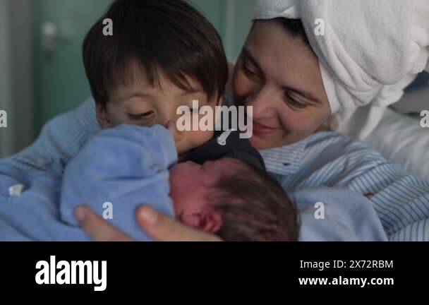 Newborn Introduction to Sibling at Hospital - Young Brother Cradles New ...