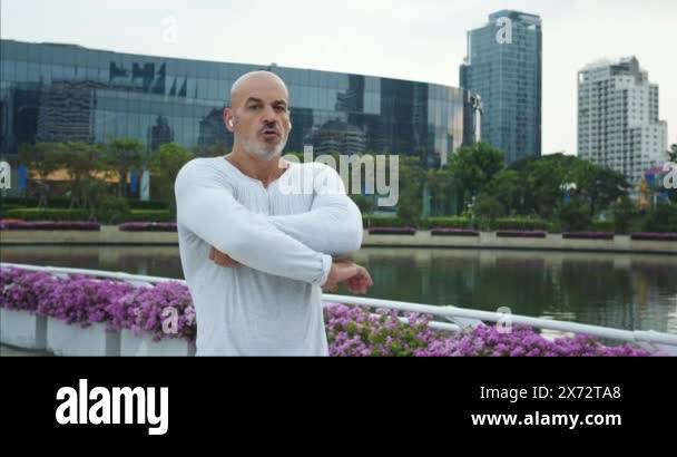 Urban park handsome caucasian older man standing arms crossed looking ...