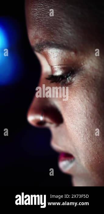 Vertical Close up young black woman indoors looking at screen making ...