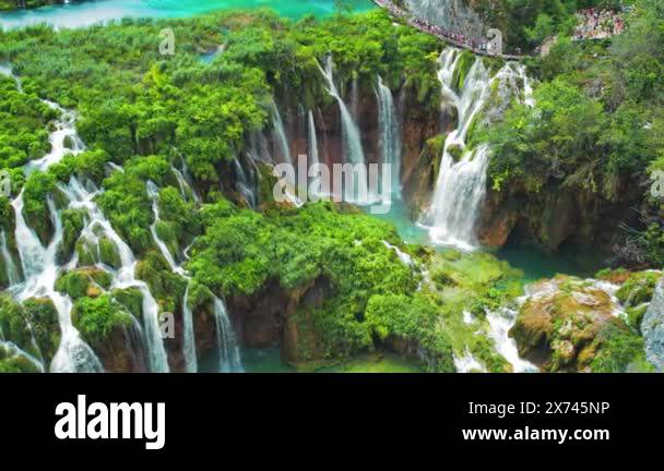 Powerful waterfall flows into a lake with azure clear water. Plitvice ...