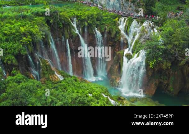 Powerful waterfall flows into a lake with azure clear water. Plitvice ...