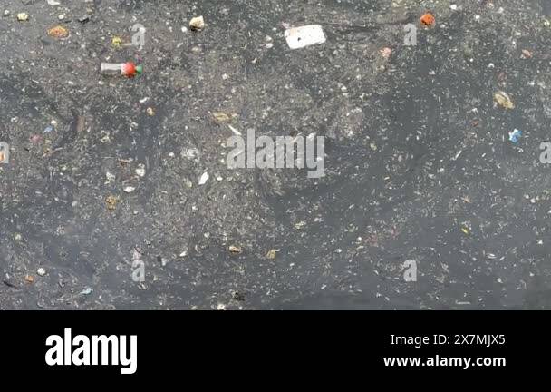 Litter in lake water. Garbage in the sea. Polluted river in the city ...