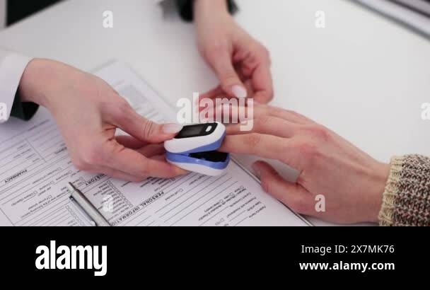Nurse uses pulse oximeter to check patient oxygen saturation. Pulse ...