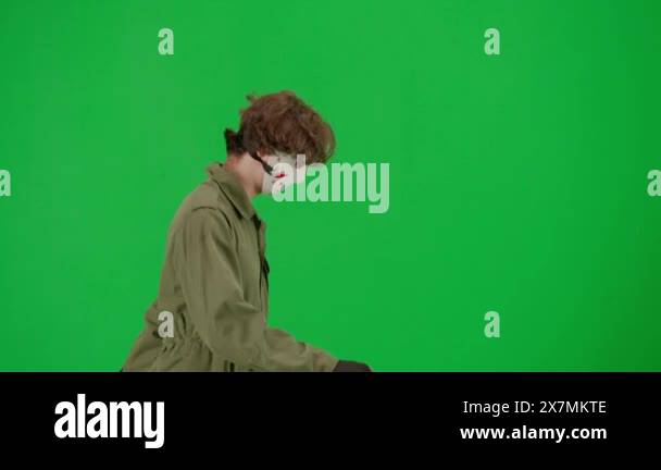 Maniac in hockey mask and jumpsuit running and waving a large sharp ...