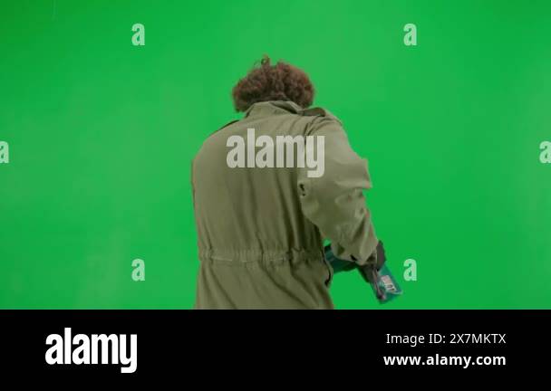 A maniac in overalls runs and swings a chainsaw. An unrecognizable man ...