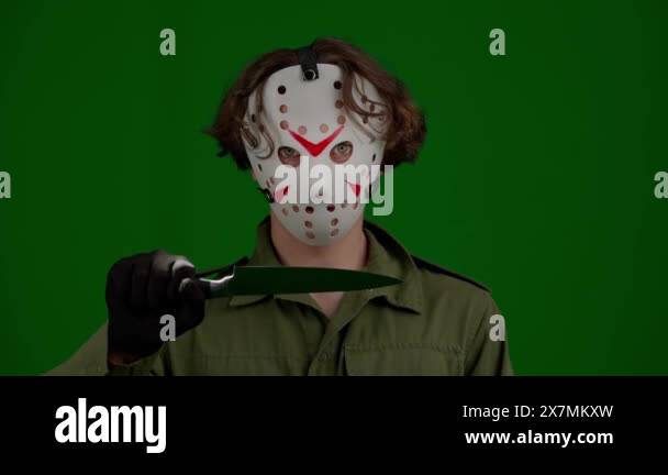 Maniac in hockey mask and coveralls holding a sharp knife ...