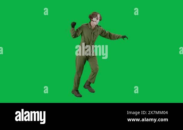 Maniac in hockey mask and jumpsuit running and waving a large sharp ...