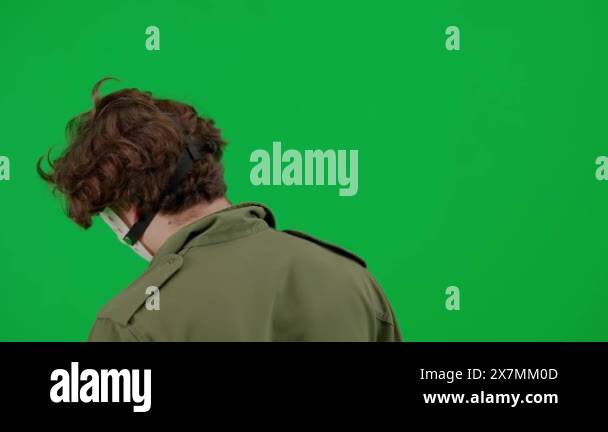 A maniac in a hockey mask folds his arms across chest and stares ...