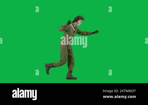 Maniac in hockey mask and jumpsuit running and waving a large sharp ...