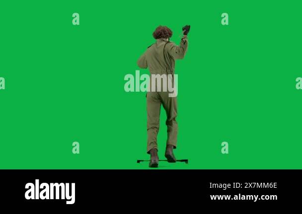 Maniac in hockey mask and jumpsuit running and waving a large sharp ...