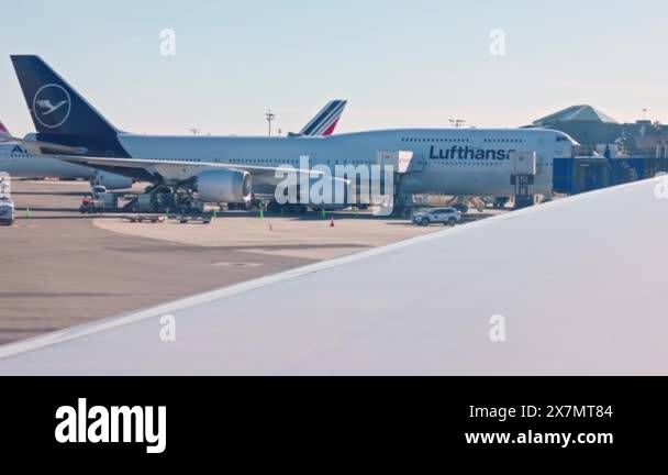 Beautiful view from the window of a moving plane at a parked Lufthansa ...