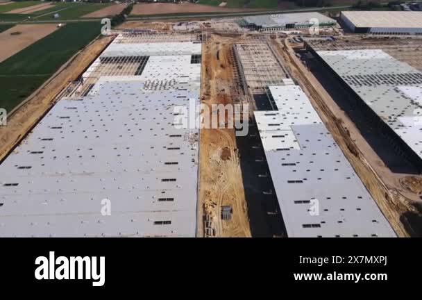 Aerial view of construction site with warehouse building under ...