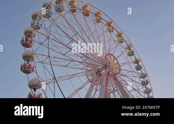 Rotating Ferris Wheel in the Amusement Park in the Evening Footage ...