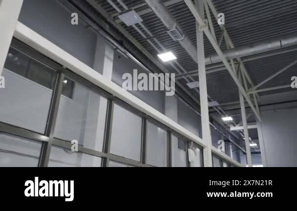 Ceiling of warehouse decorated with square lamps. Modern lamps attached ...