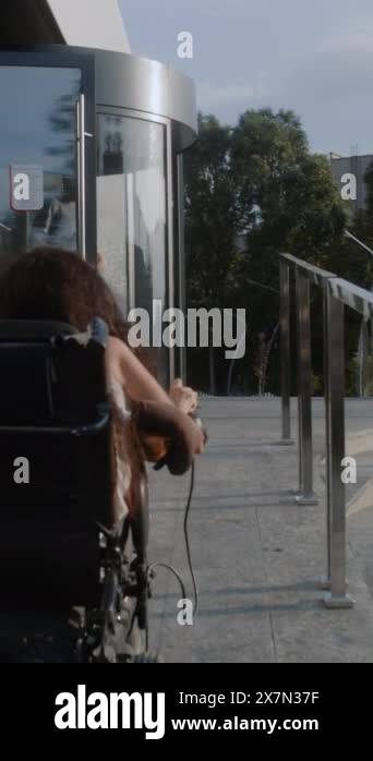 Woman with physical disability rides into clinic entrance on motorized ...