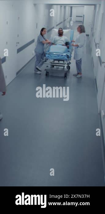 Female doctor and nurse stand in hospital corridor with African ...
