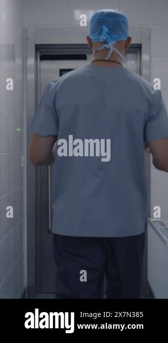 Surgeon comes to operating room after cleaning hands and puts on lab ...