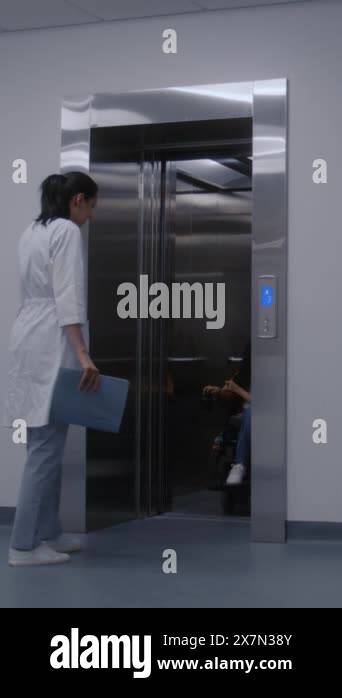 Woman in motorized wheelchair leaves elevator with doctor, rides along ...