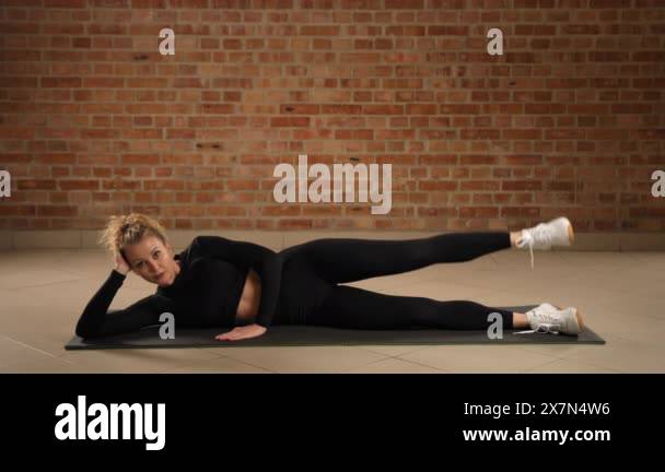 Engaging in left leg lifts, the athlete concentrates on enhancing ...