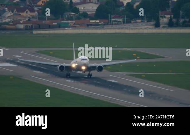 Jet passenger plane is landing and touching, braking, spoilers up ...