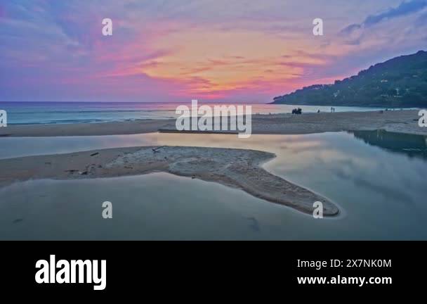 Time lapse colorful sunset reflection in the beach puddle. The colors ...