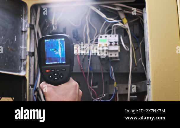 A thermal imaging camera is used to inspect an electrical panel for ...