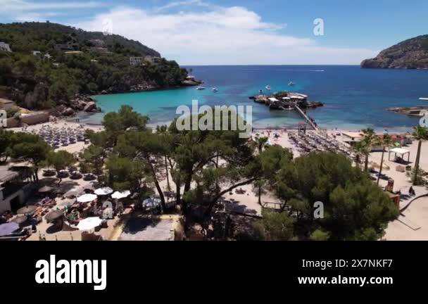 A birds-eye view of a boat sailing in the water at Camp de Mar Beach in ...