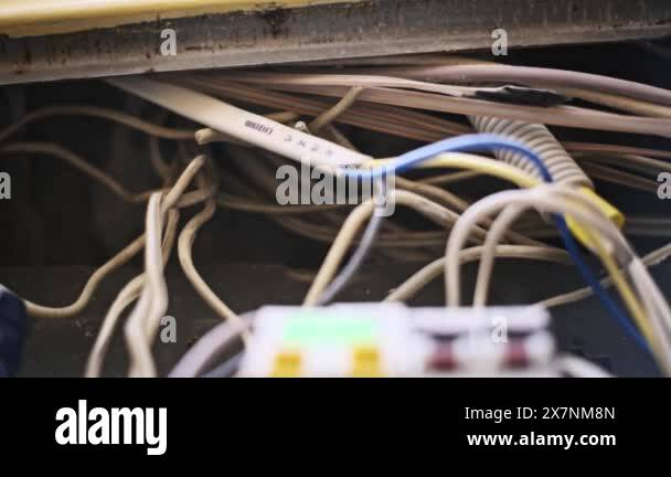 A junction box with exposed electrical wires and connections ...