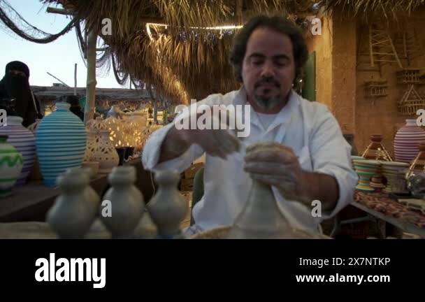 Doha , Qatar- November 29 2023: Traditional Arabic potter making clay ...