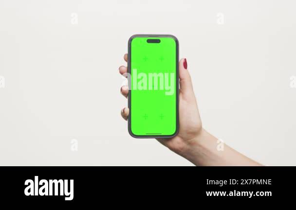 A close-up image of a hand holding a smartphone vertically, displaying ...