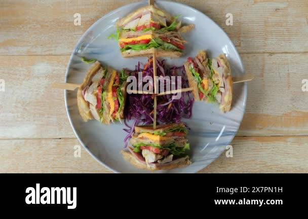 Gourmet club sandwich with grilled chicken, crispy bacon, fresh lettuce ...