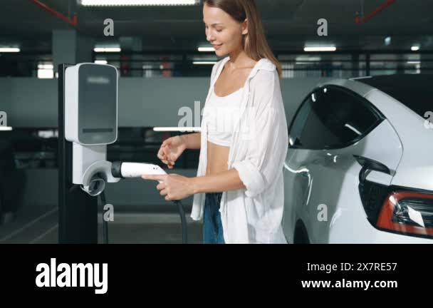 Slow motion woman happy and smile travel with EV electric car to shopp ...