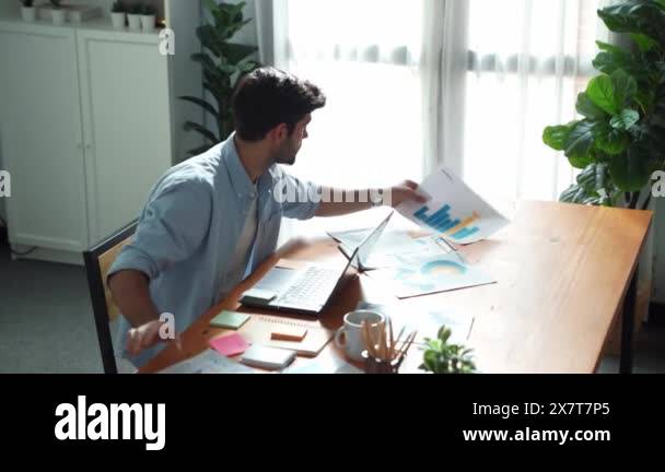 Skilled businessman writing idea on colorful sticky notes while looking ...