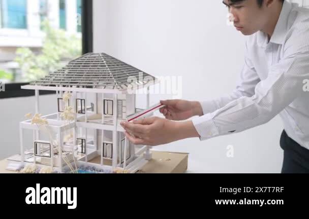 Close up of professional male architect engineer measure house model ...
