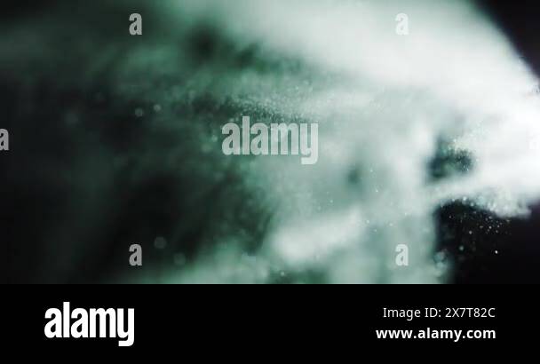 Shimmering dust particles dancing in a radiant projector beam, creating ...