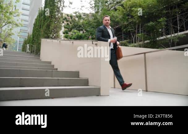 Worried smart business man running up stairs with hurry at green eco ...