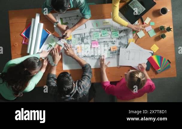 Top down aerial view of civil engineer hold project plan while design ...