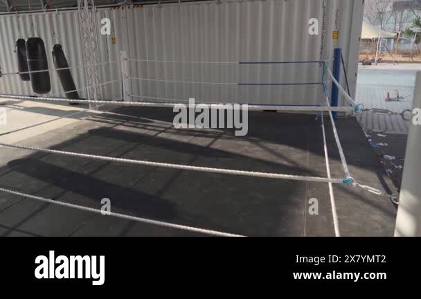 Empty boxing and martial arts area on street gym with many punching ...