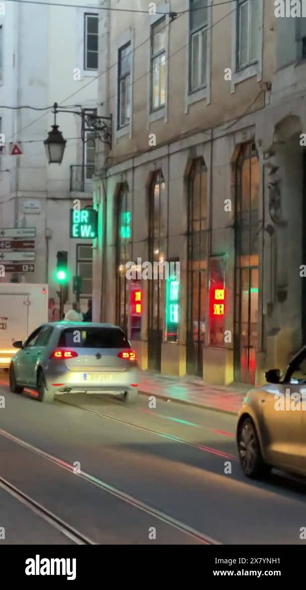 Lisbon, Portugal, a vibrant urban scene at night, highlighted by neon ...