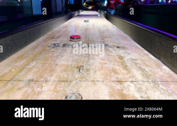 Closeup of Weights on Shuffleboard Table. Slow motion shuffle board ...
